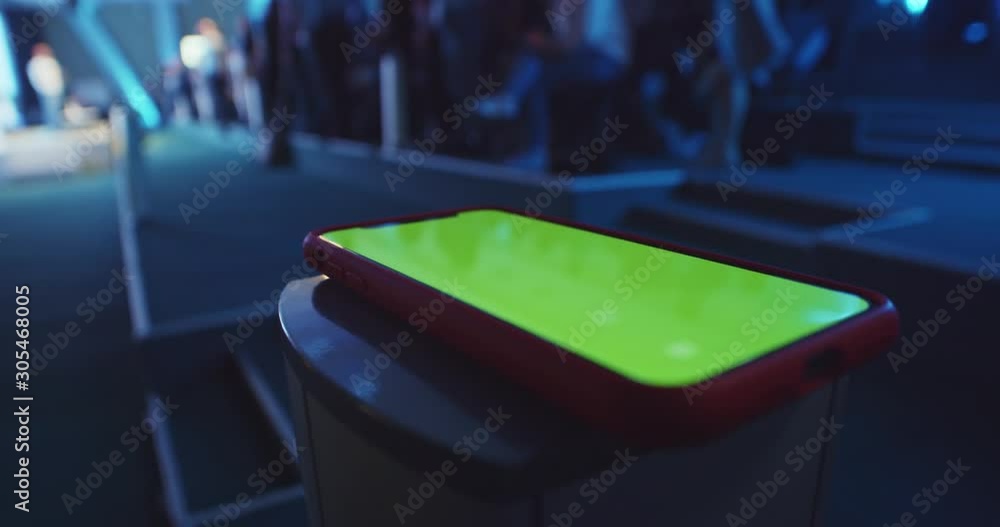 Green screen smartphone mobile with conference audience on background ...