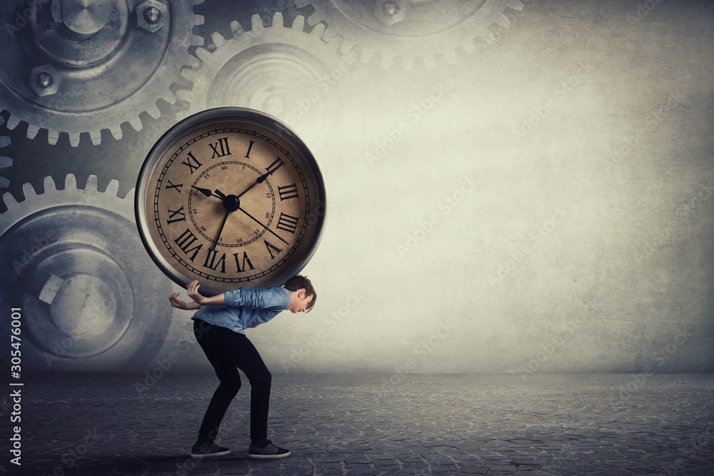 Bent down guy carrying a big heavy clock on his back. Overloaded ...