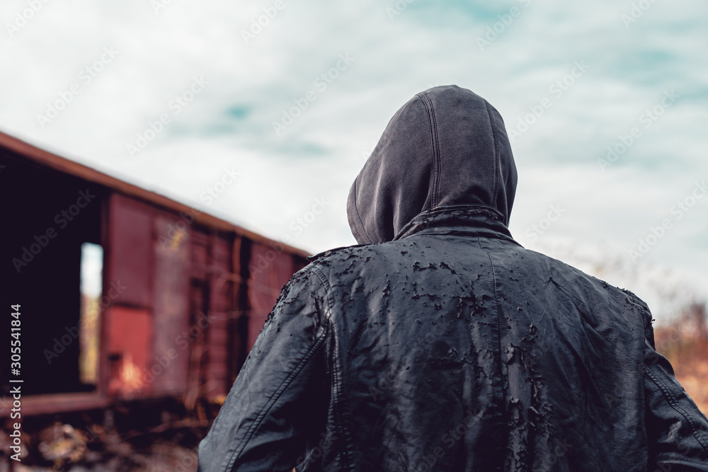 Homeless immigrant walking by freight train wagons Stock Photo | Adobe ...