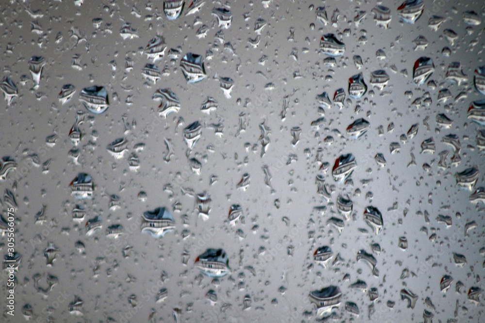 Window glas with rain drops; water drops and window wire mesh viewed ...