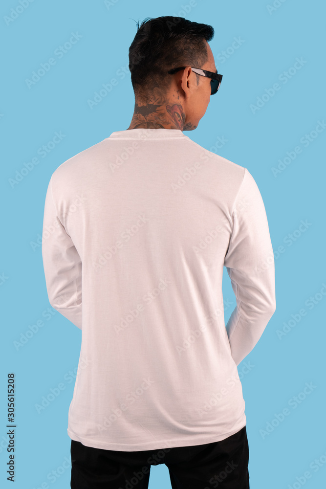 Black man tattooed wearing white long sleeve t-shirt in back view ...