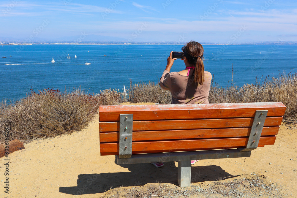 Rear view of a Filipino American woman taking a photo from the Cabrillo ...