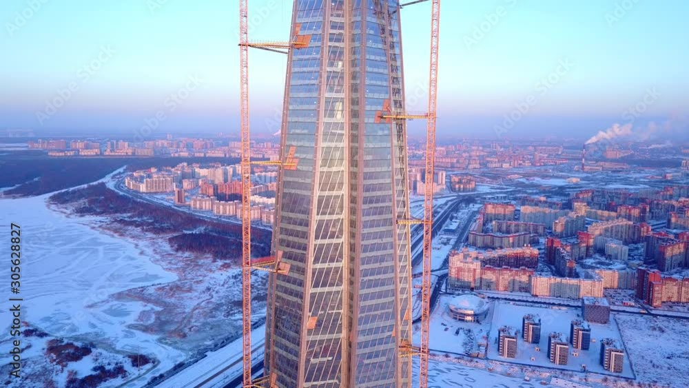 Glass walled twisting facade of supertall skyscraper, construction of ...