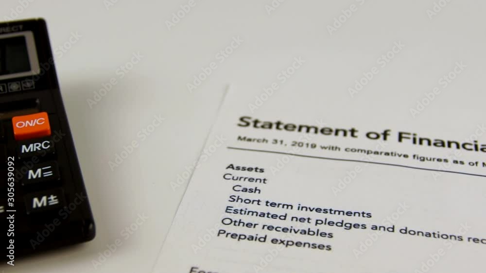 Sheet a statement of financial position and calculator on a white ...