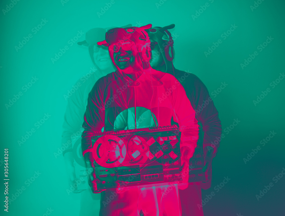 Blurred photo. Man in cosplay costume of a cow with reel tape recorder ...