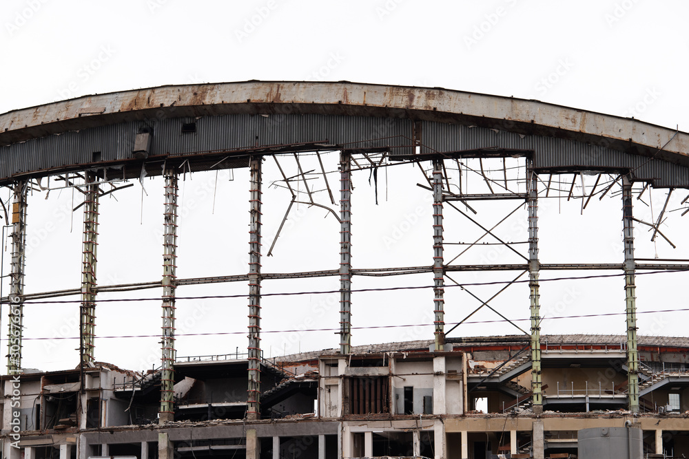 Demolition of the arena. Old metal frame of the building, destroyed ...