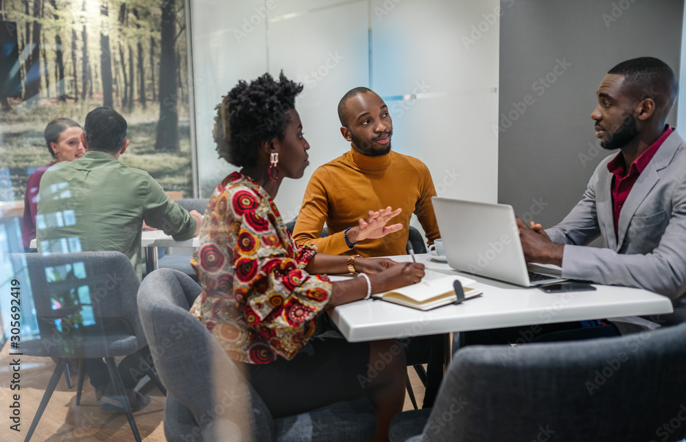 Black african business team meeting in discussion sitting in office ...