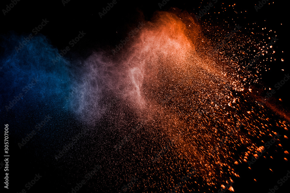 Orange blue powder explosion on black background.Orange blue color dust ...