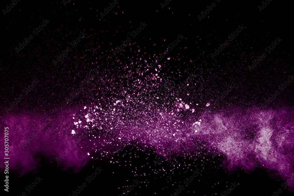 Purple color powder explosion cloud on black background.Closeup of ...