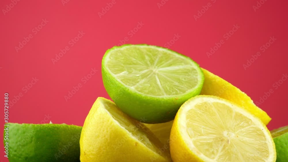 In front of a deep red studio backdrop, a portion of chopped lemon and ...