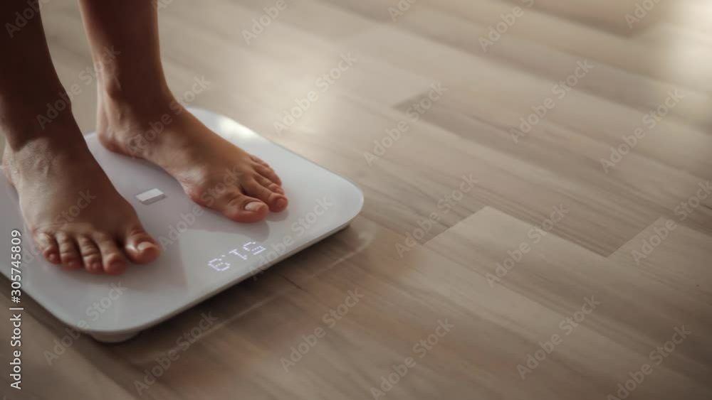 Woman On Scales Measure Weight.Girl Legs On Bathroom Scale.Weighing ...