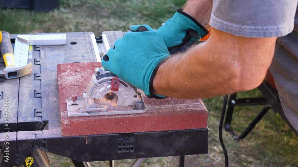 Tile cutter industry equipment. Worker cutting paving tiles for laying ...