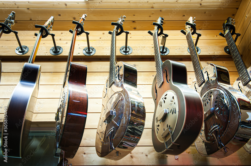 Dobro resonator guitars collection aligned in showroom Stock Photo ...