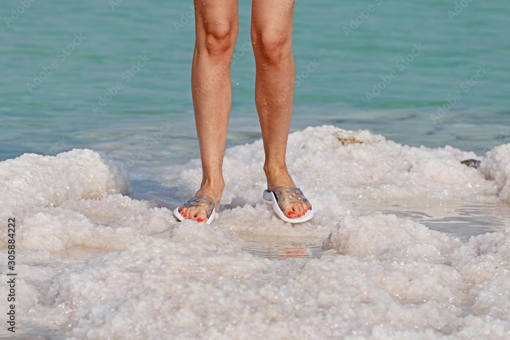 girl's legs against the background of sea and salt, dead sea Stock ...
