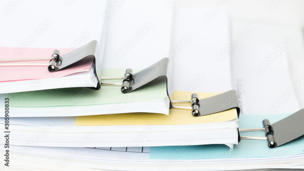 Stack of office working document with black paper clip folder separated ...