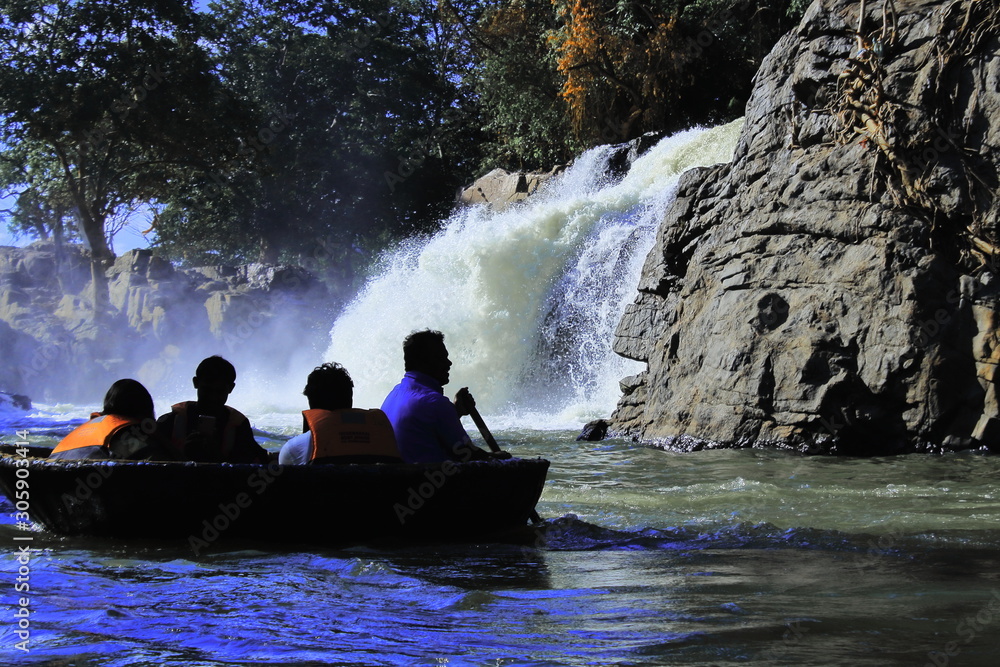 tourists are enjoying coracle ride on kaveri river at hogenakkal falls ...