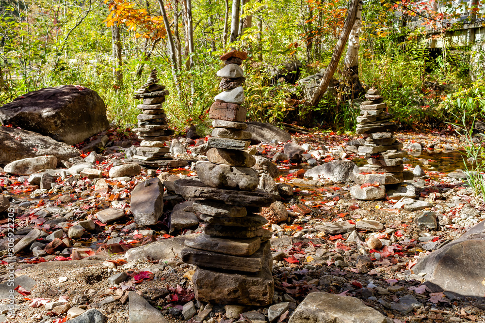 Pebbles, stacked stones as stone statues on the Muskoka river bay ...