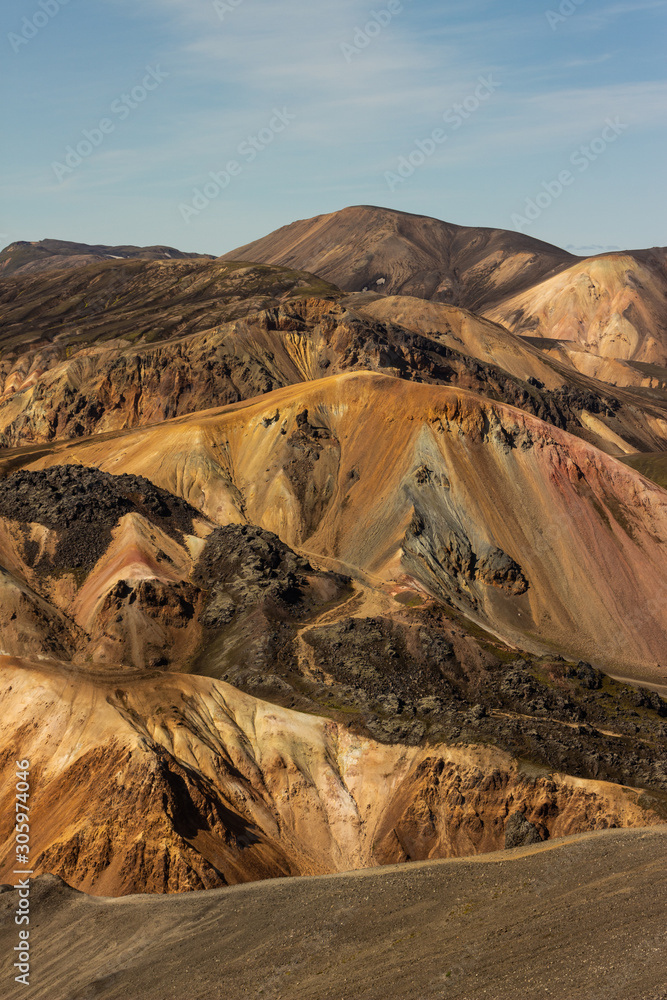 Colorful layered hills, rocky and sandy rainbow mountains ...