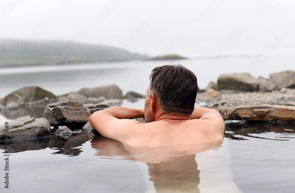 Man bathing and relaxing in hot springs during summer day. Natural hot ...