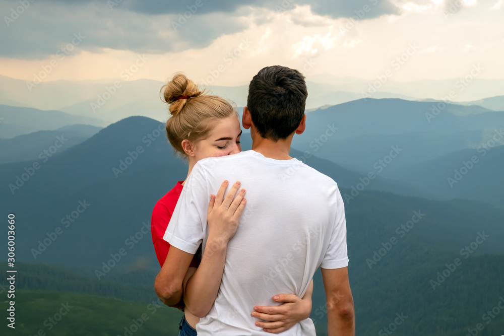 Loving girl is sad while saying goodbye and hugs a young guy in the ...