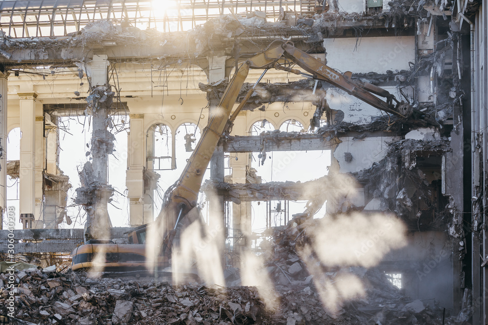 Building demolition excavator with long mechanical arm. Destruction of ...