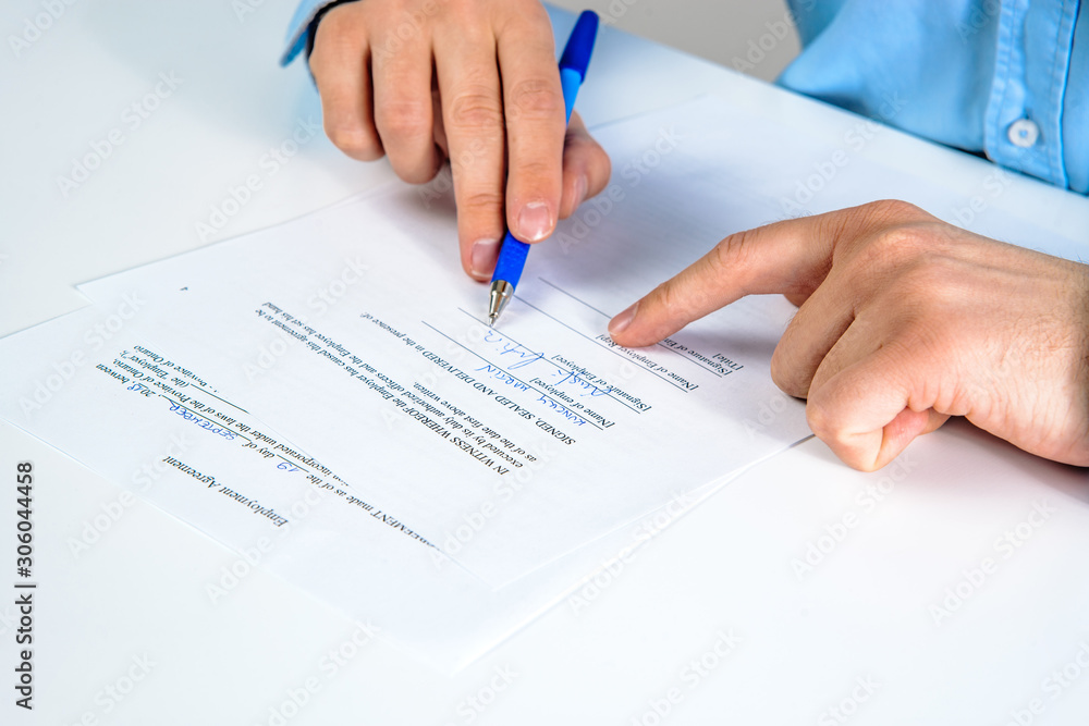 Signing contract. Business concept, hiring employees. The man signs the ...