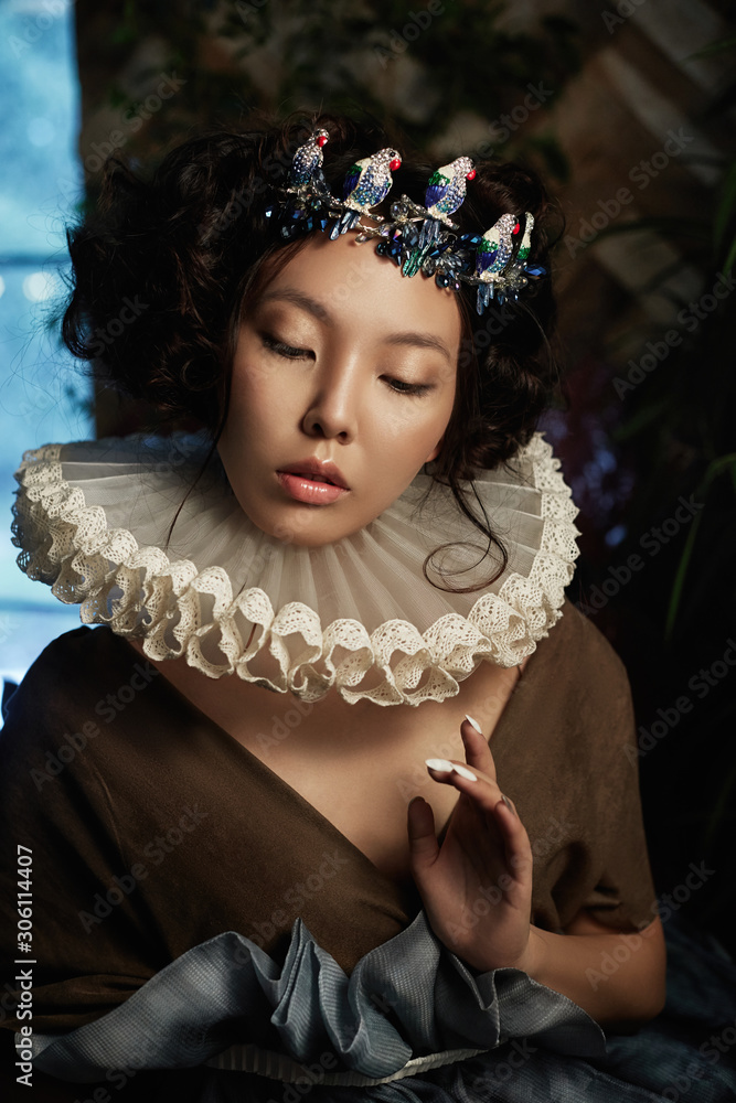 Art portrait of a girl Princess Queen in foliage and greenery, fabulous ...