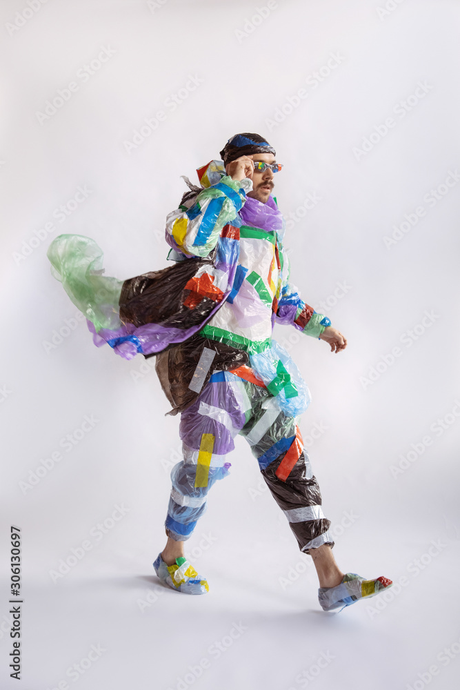 Man wearing plastic on white background. Male model in clothes made of ...