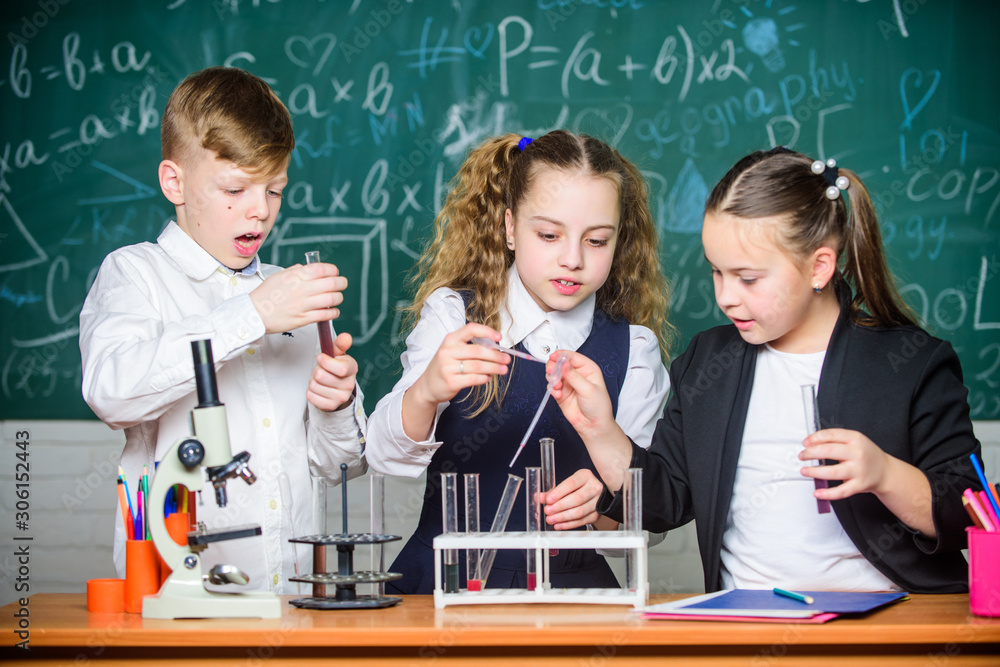Girls and boy student conduct school experiment with liquids. School ...