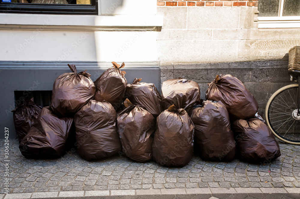 A Stack of full bin bags garbage trash black junk dumped on the ...