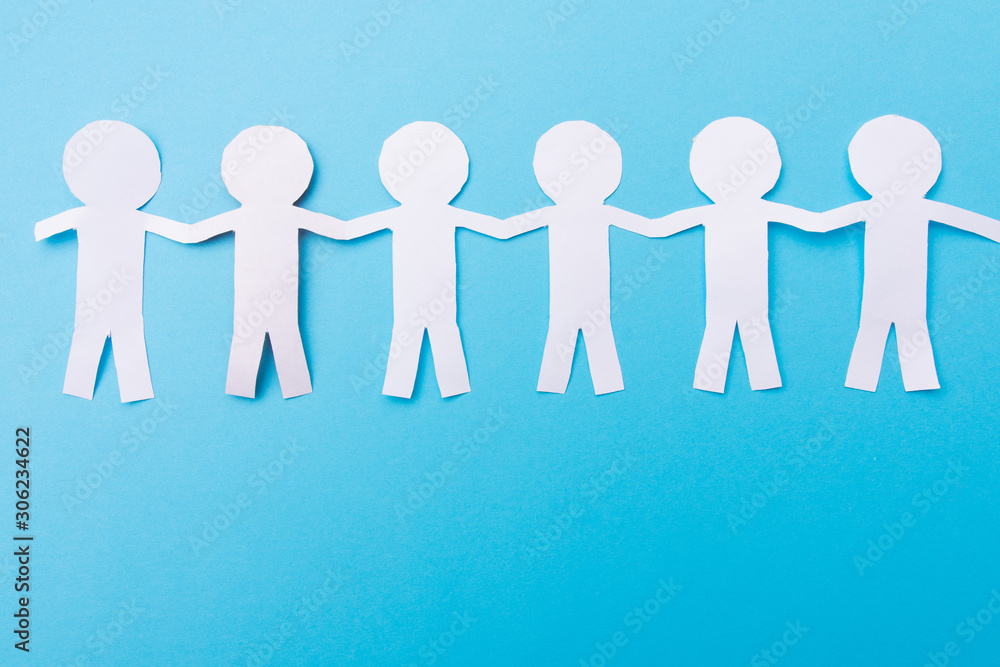White paper people holding hands. Blue background Stock Photo | Adobe Stock