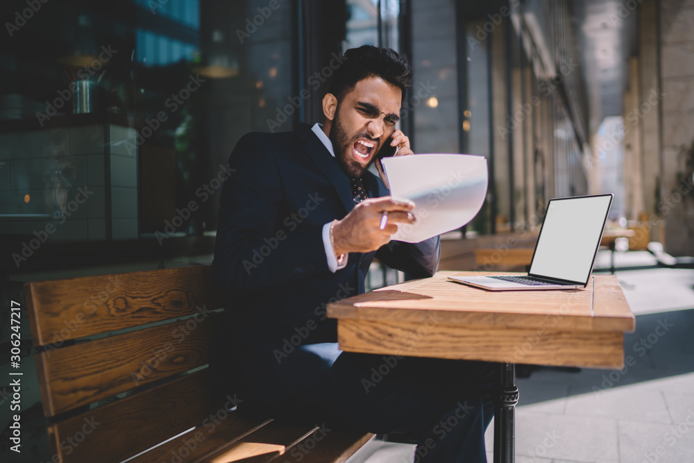 Angry turkish man in formal wear feeling rage while checking data from ...