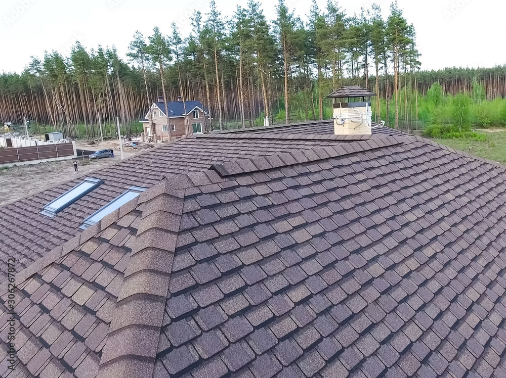 Bituminous tile for a roof. House with a roof from a bituminous Stock ...