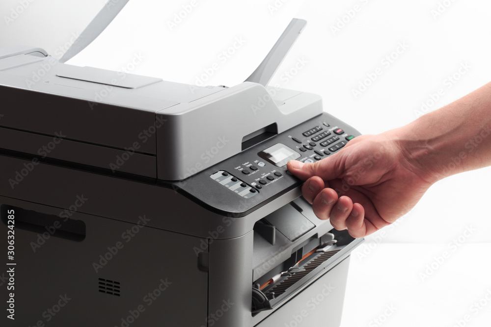 Hand press button on panel of printer. printer scanner laser office ...
