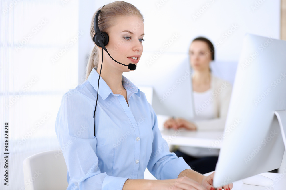 Call center office. Beautiful blonde woman using computer and headset ...