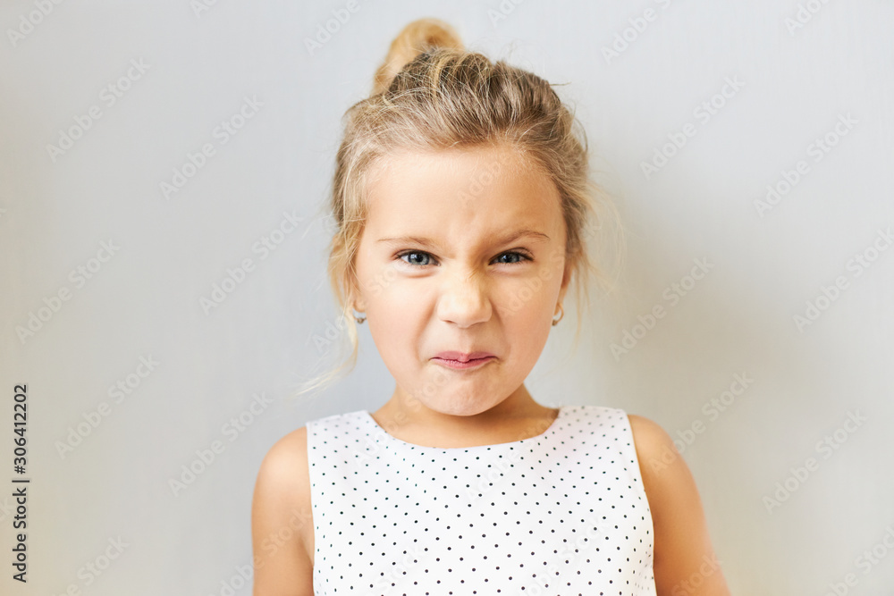 Negative human emotions and reaction. Isolated shot of displeased ...