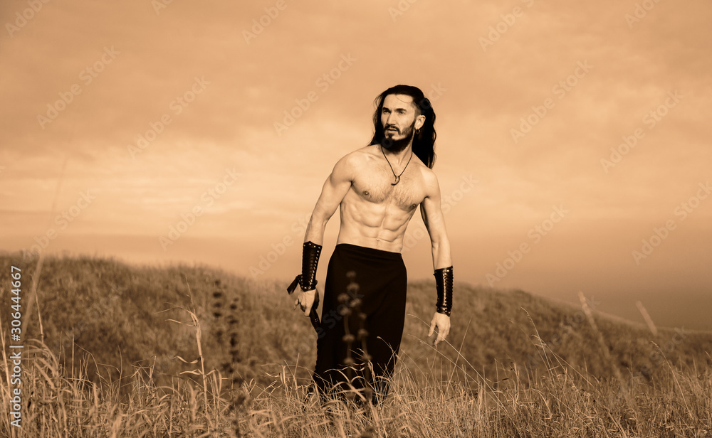 Young ukrainian man with long hair at the open steppe in Ukraine ...