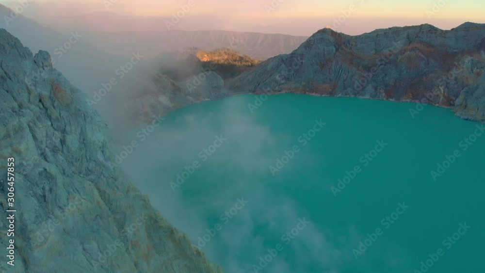 Aerial shot. Sunrise at a famous active Ijen volcano or Kawah Ijen on ...