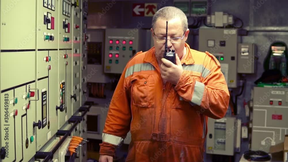 Marine Engineer working on radio communication at Engine Control room ...