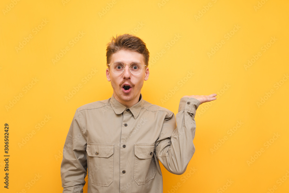 Portrait of surprised geek with glasses and mustache on yellow ...