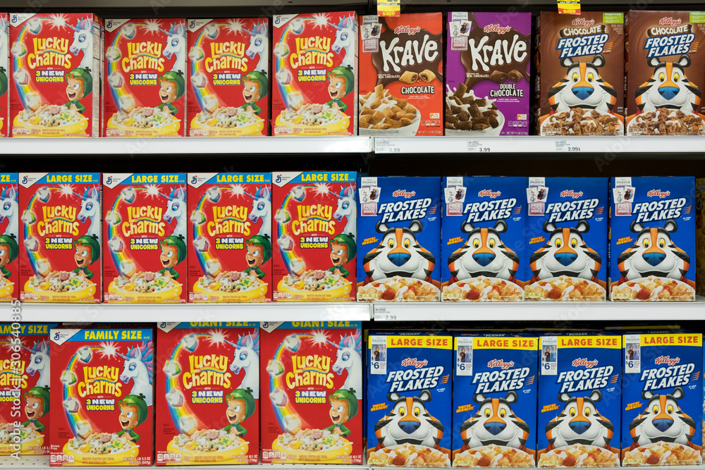 Grocery store shelf with boxes of various brands of breakfast cereal ...