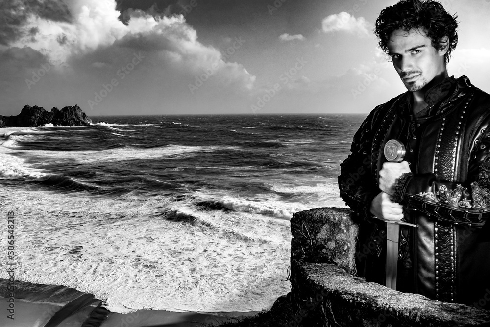 Black and white portrait of knight standing on castle balco with sword ...