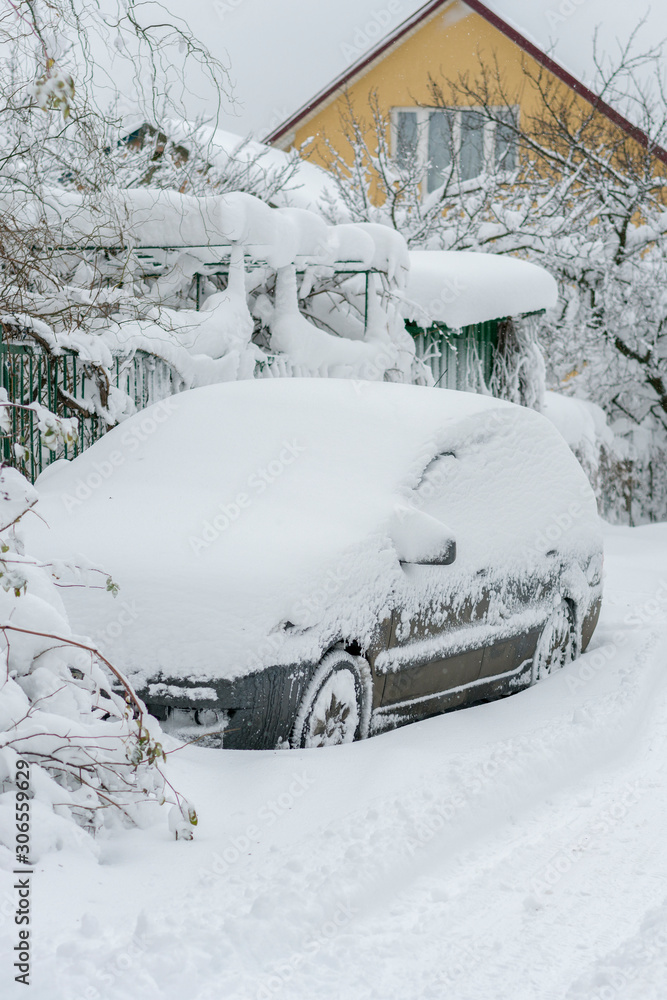 Snow-covered machine. Car under the snow. Lots of snow and big ...