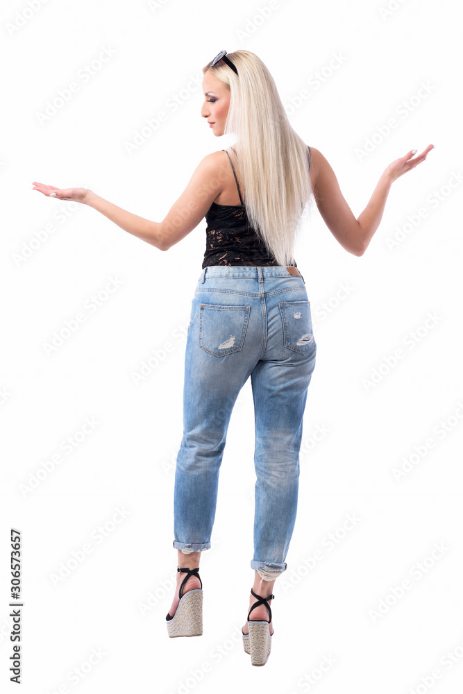 Back view of blonde hair young beauty girl with open hands choosing or ...