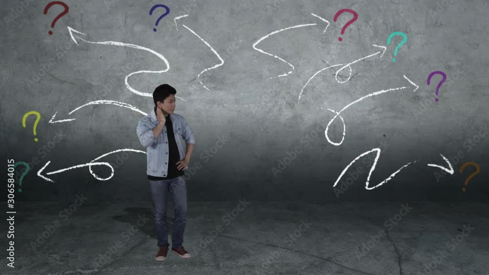Young man walking back and forth in front of arrows symbol and question ...