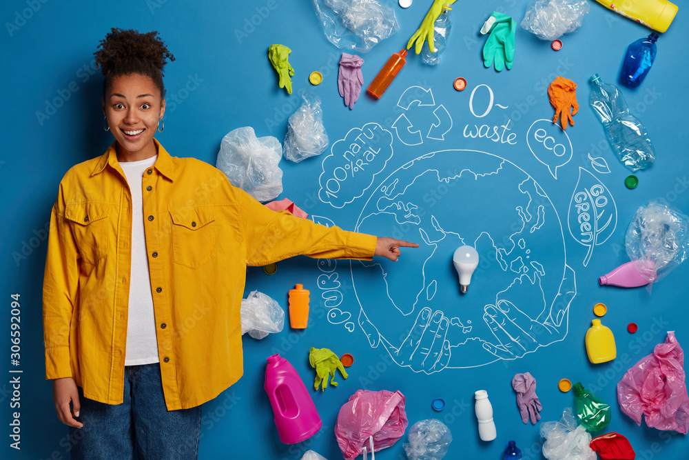 Positive dark skinned woman demonstrates her plan about cleaning Earth ...