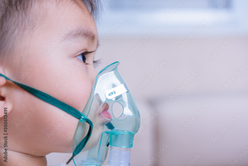 Closeup asian face little children boy using steam inhaler nebulizer ...
