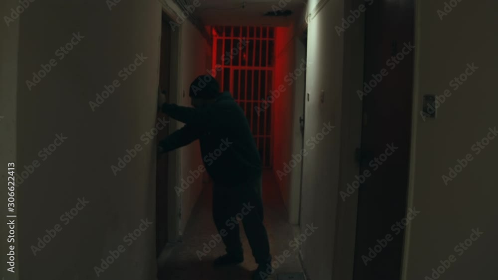 Alcoholic male stumbling in decrepit ghetto building corridor.A drunk ...