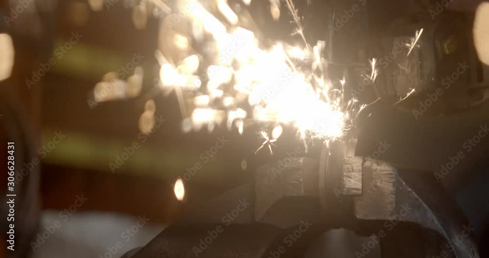 Steel worker with angle grinder making hot glowing sparks Stock Video ...