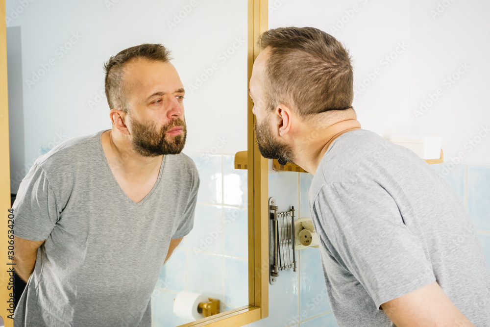 Guy Looking In The Mirror